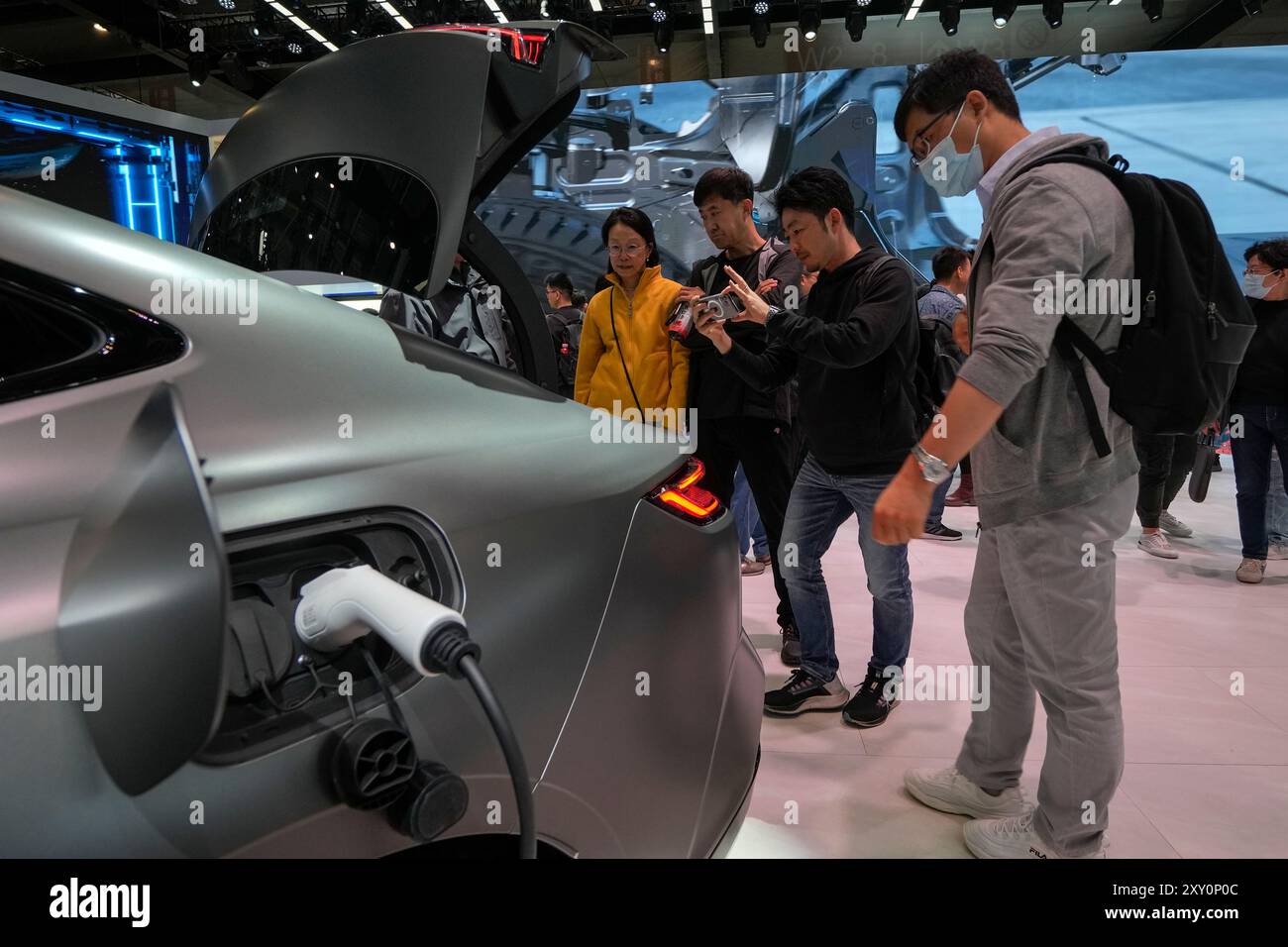 FILE - Visitors look at a Geely Galaxy E8 EV car model during the Auto ...