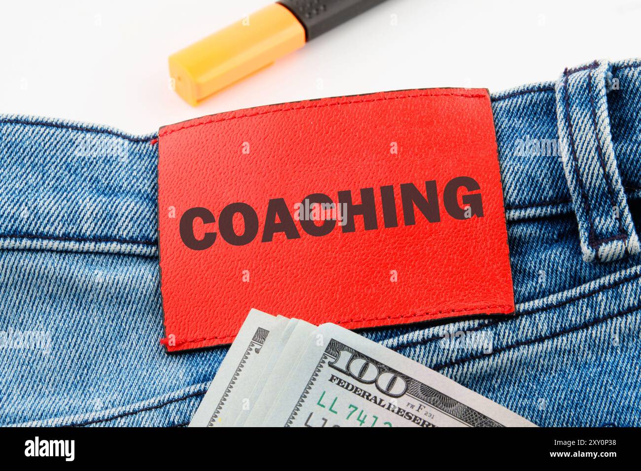 COACHING written on the jeans tag Stock Photo - Alamy
