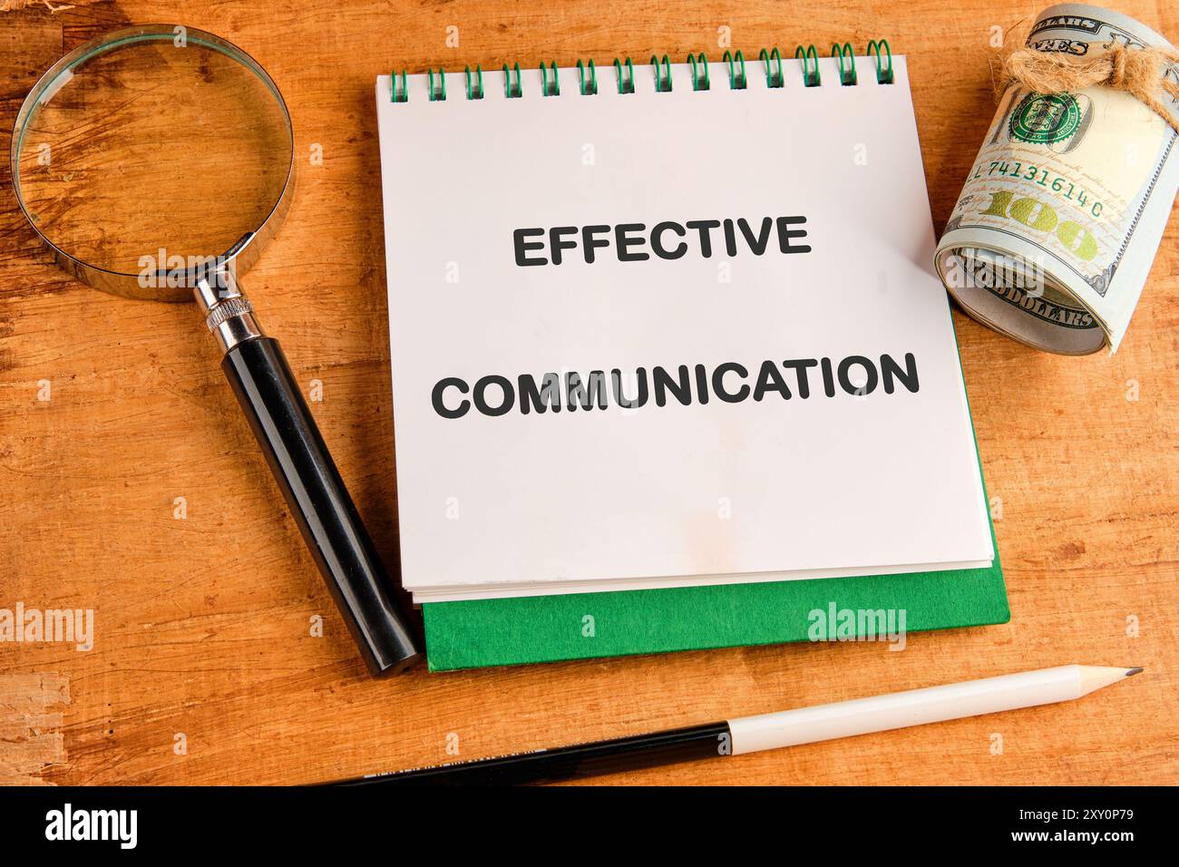 Info concept. EFFECTIVE COMMUNICATION words in a notebook on a papyrus ...