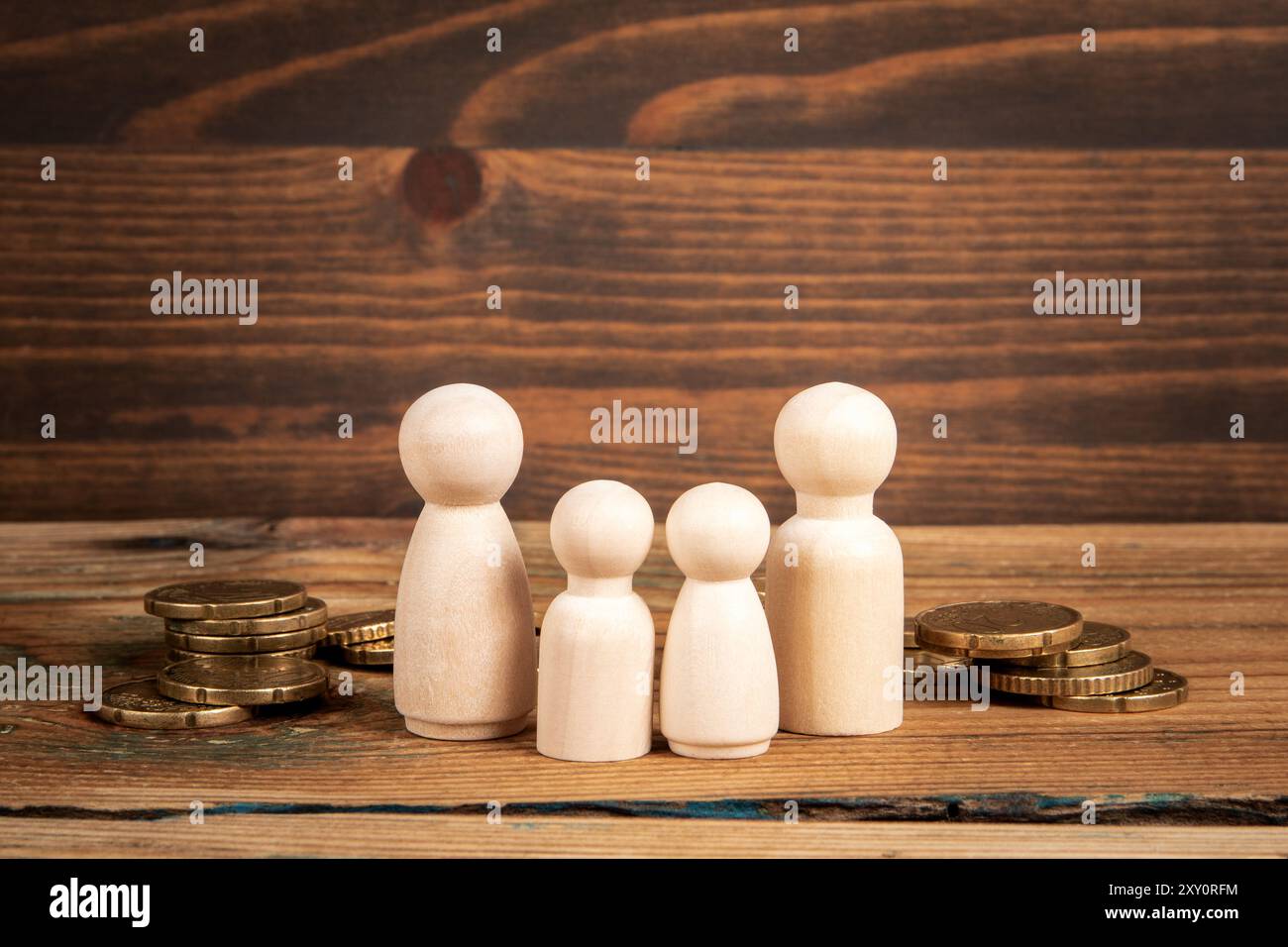 Family Budget Concept. Miniature human figures and money on a wooden ...