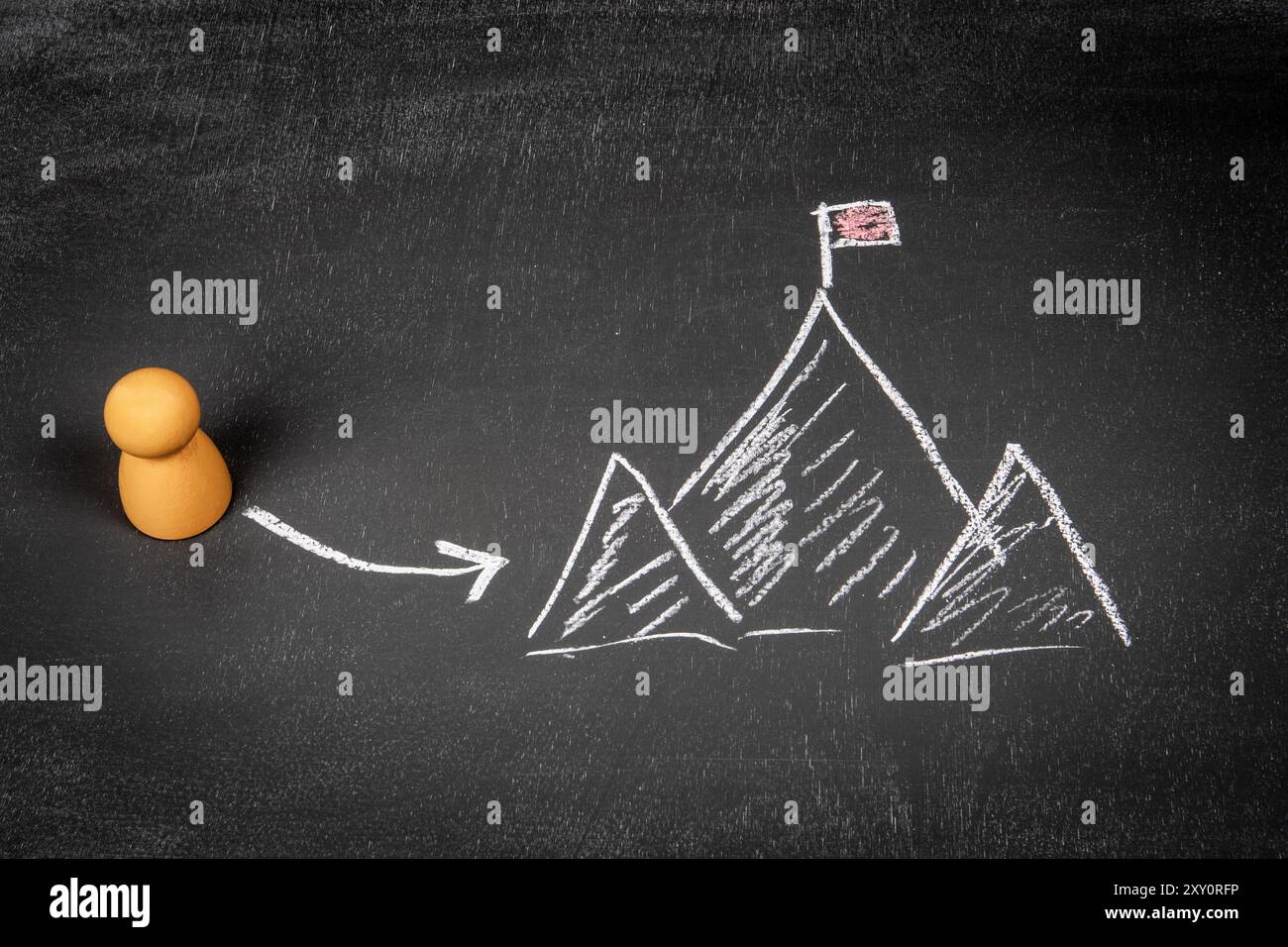 Setting and achieving goals concept. Wooden human figures on a ...