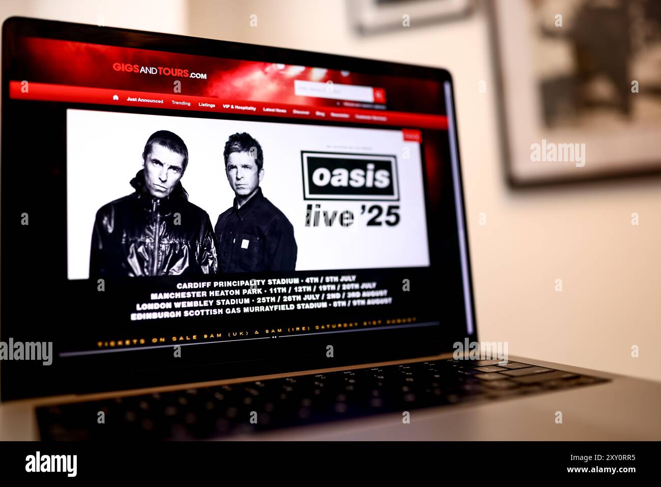 The Gigs and Tours website, shown on a computer laptop screen, displays ...