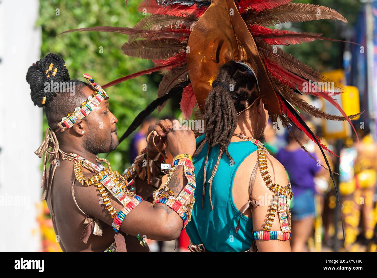 Male participants preparing their elaborate costumes at the Notting Hill Carnival Grand Parade ...