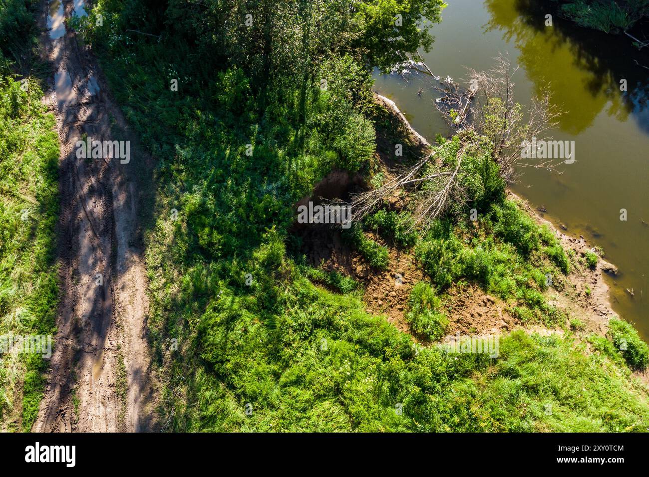 Country road passing next to steep river bank, view from above Stock ...
