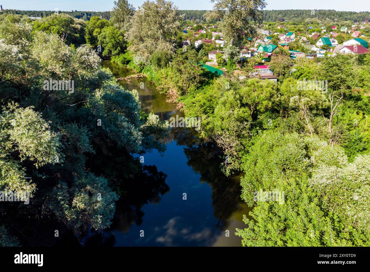 Landscape with a view of a small river and country houses on the bank ...
