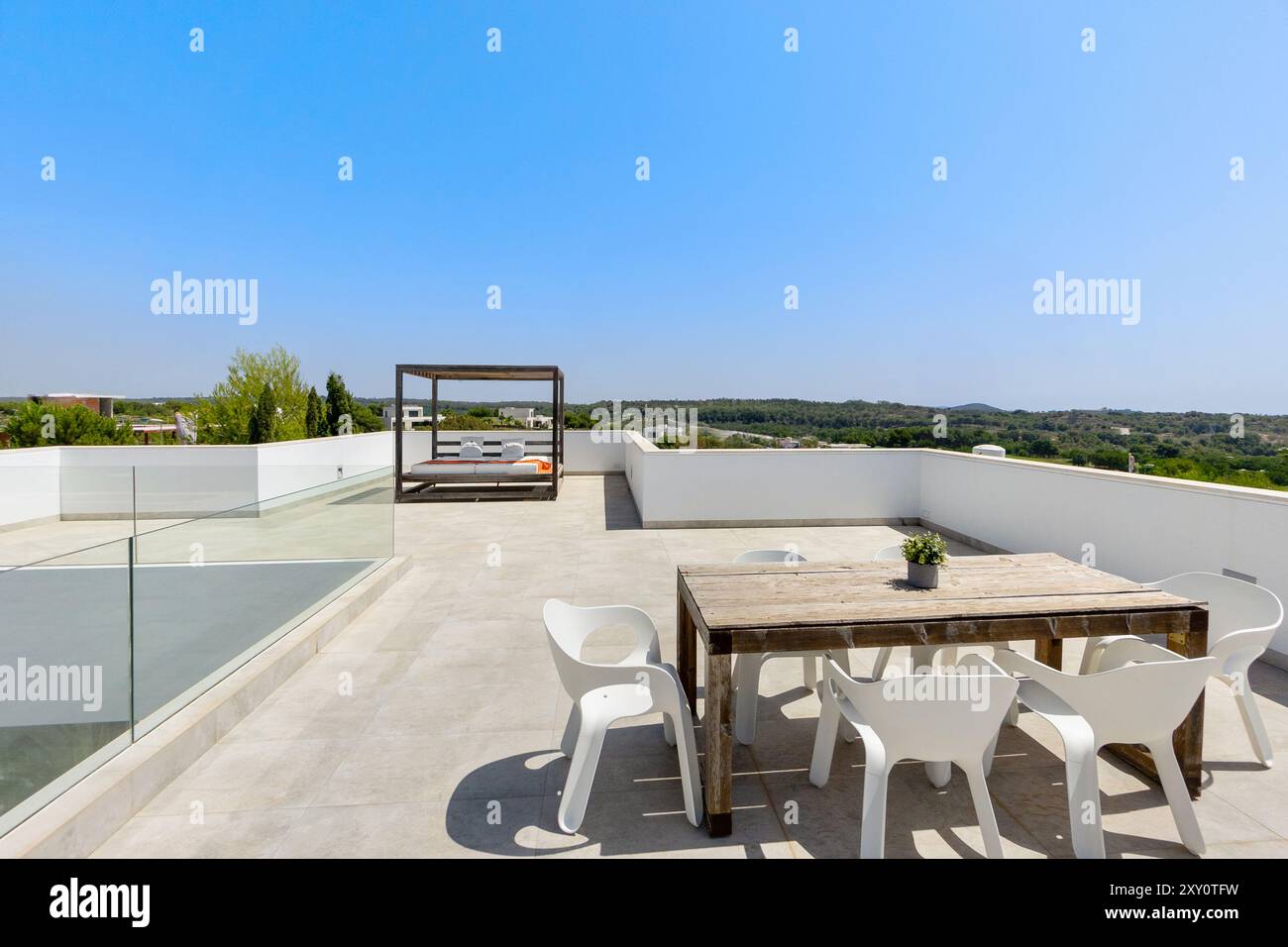 A spacious and modern rooftop terrace, featuring a stylish pergola ...