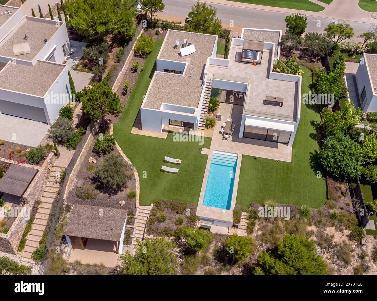 This aerial shot captures a modern, sprawling luxury residence equipped ...