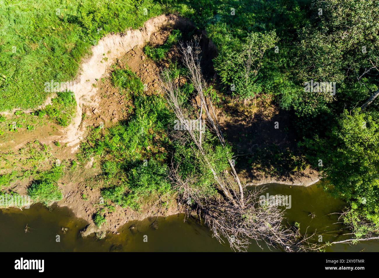 Sliding soil due to erosion on the shore of a reservoir, aerial view of ...