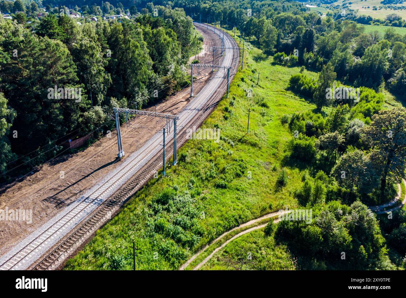 Aerial view of an electrified railway going around a bend in the ...