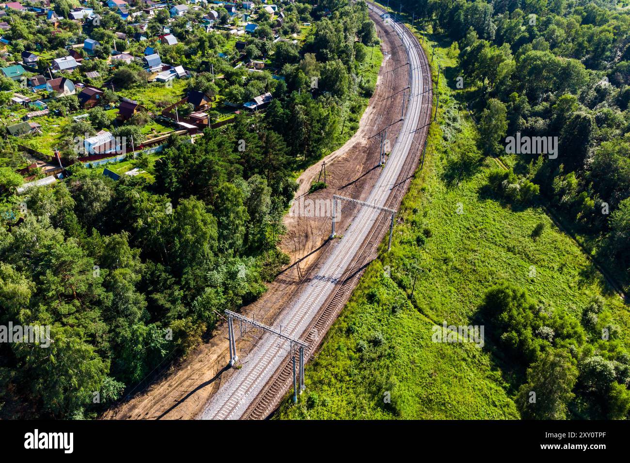 Aerial view of an electrified railway going around a bend in the ...