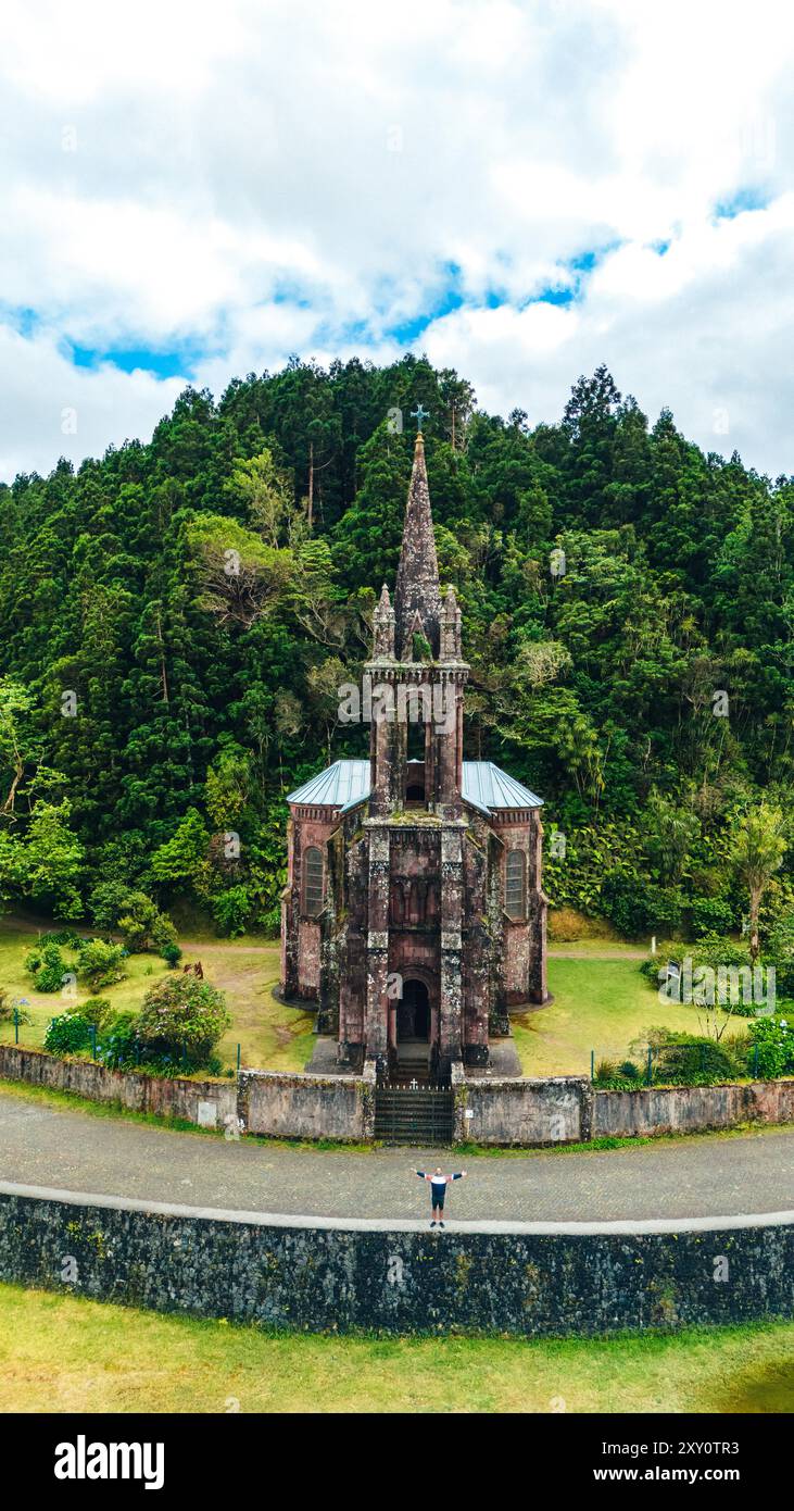 A stunning view of a historic stone church nestled in the dense ...