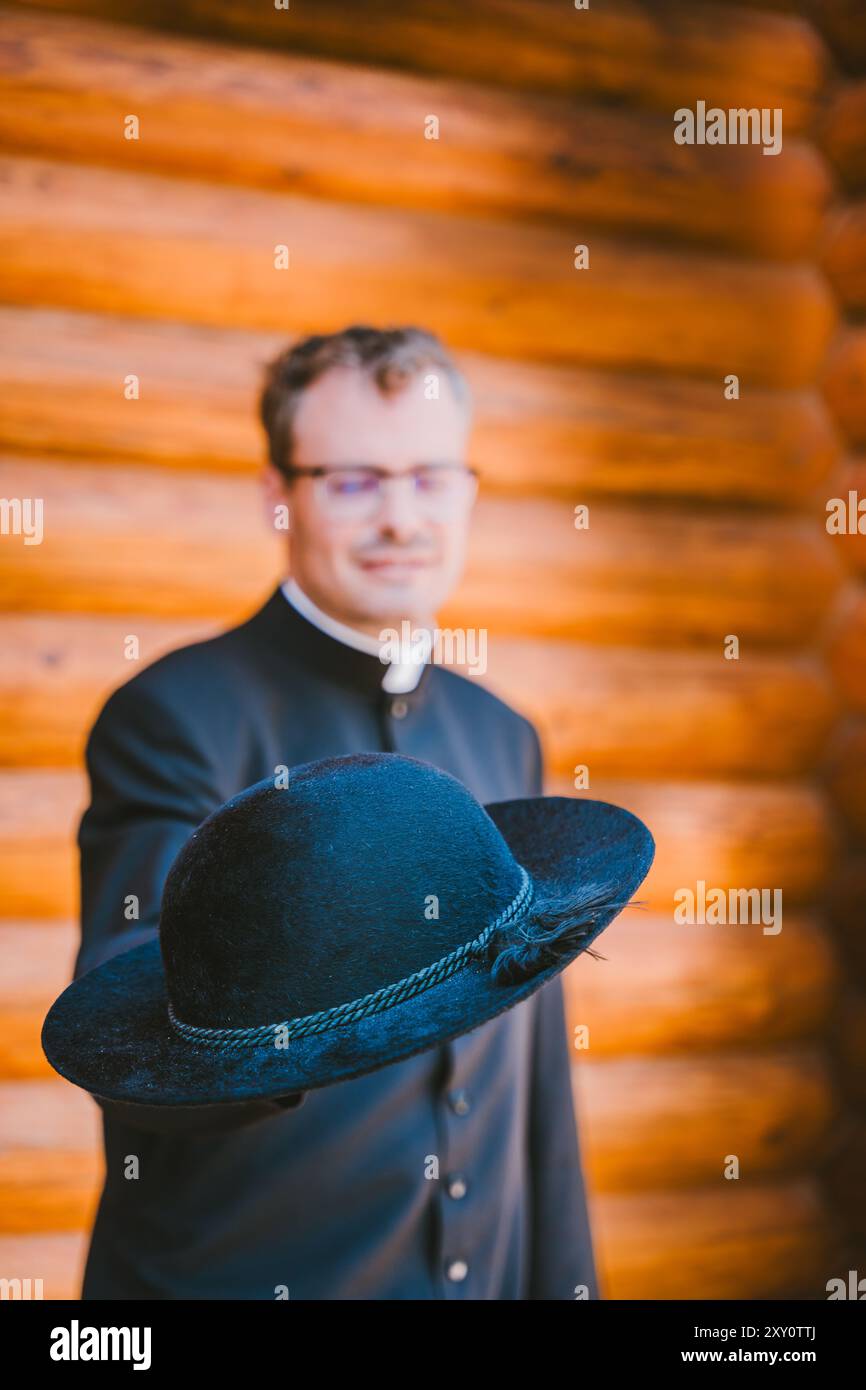 Blurred unrecognizable Caucasian male Catholic priest holding a ...