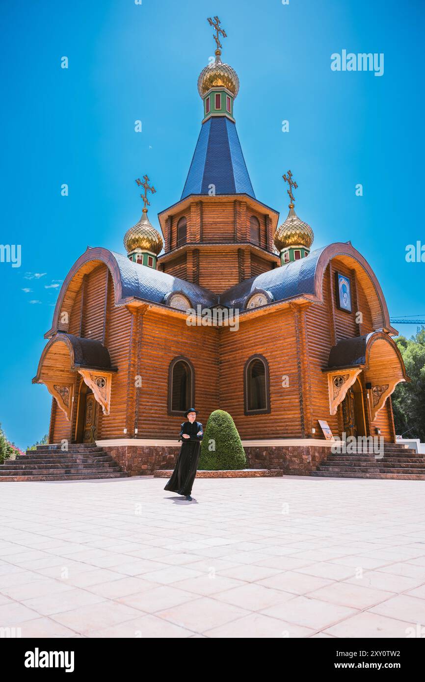 Catholic priest, male, dressed in traditional black attire, standing ...