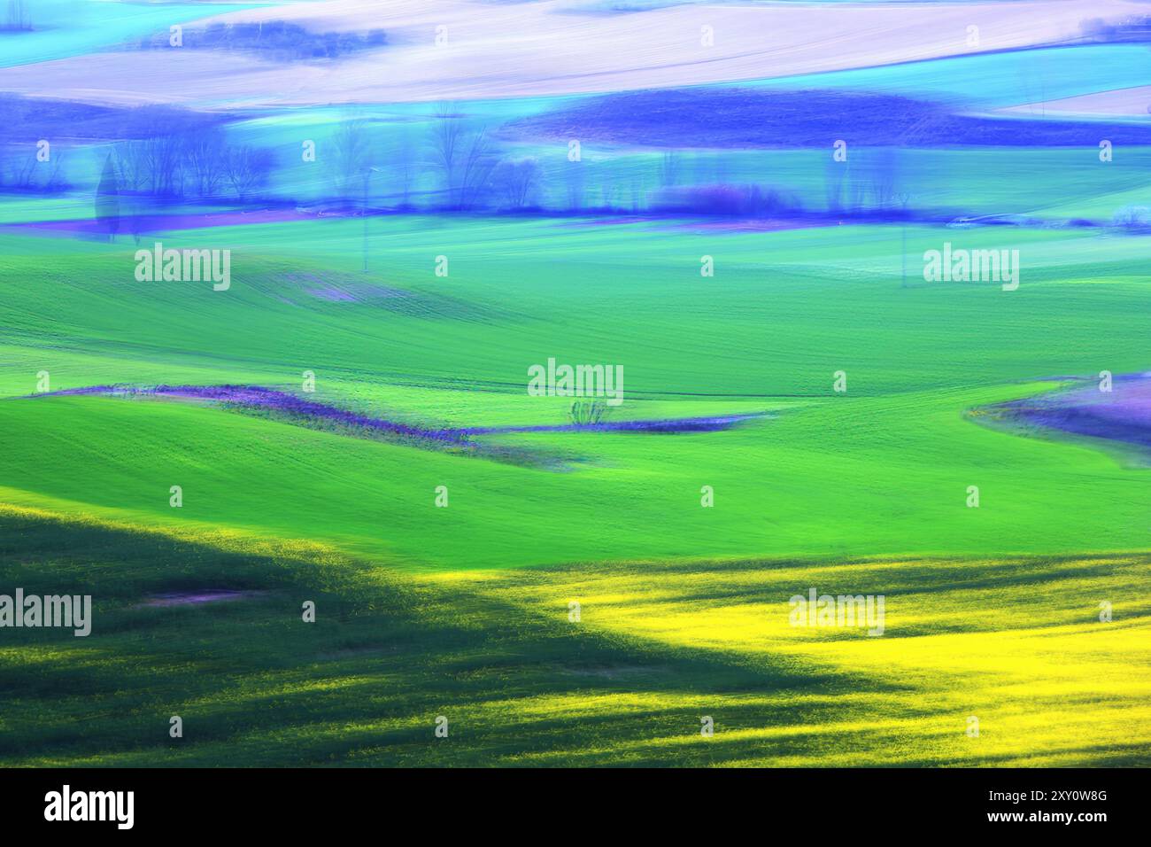 This surreal landscape features bright, rolling fields under a dynamic ...