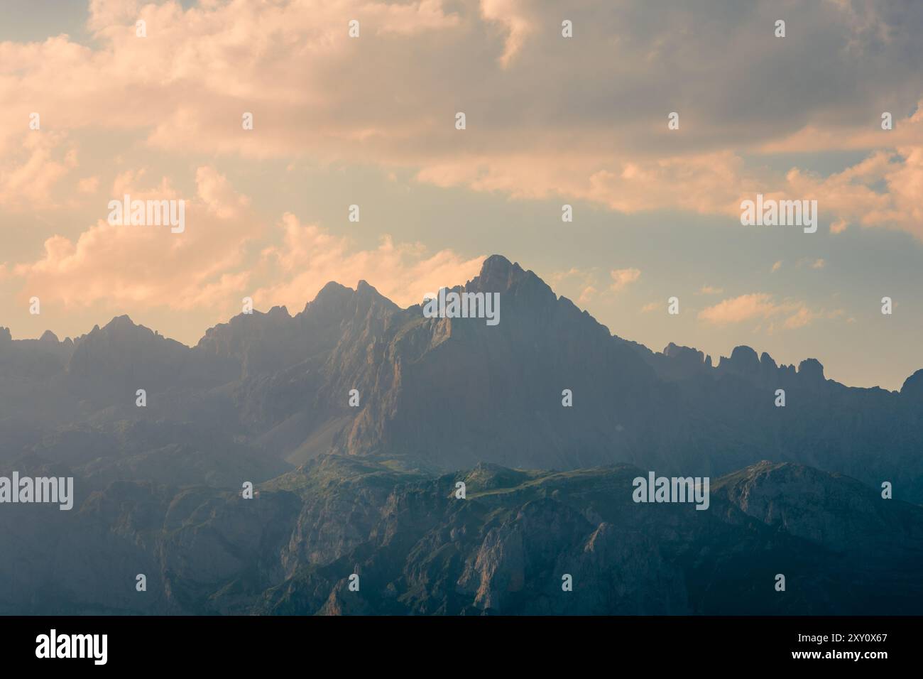 Peaks of Picos de Europa bathed in a warm sunset glow, showcasing the ...