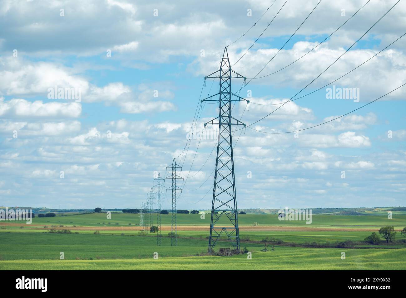 Power lines and towers stretch across a serene rural setting under a ...