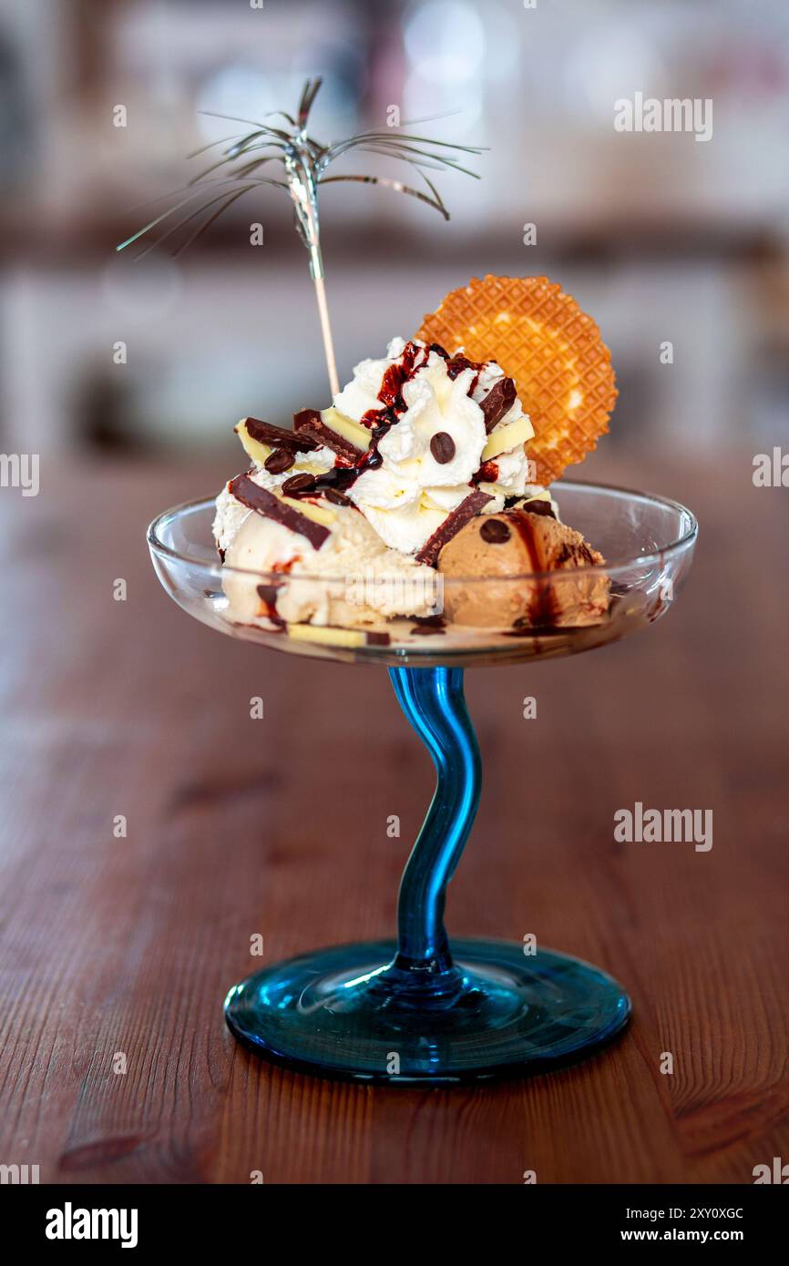 A decadent ice cream sundae featuring multiple scoops adorned with ...