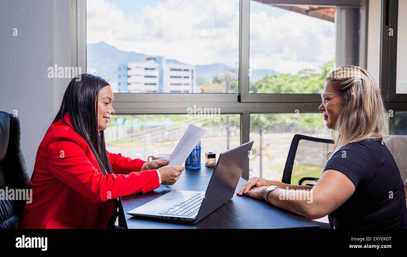 Two Latin Hispanic female lawyers collaborate in a modern office ...