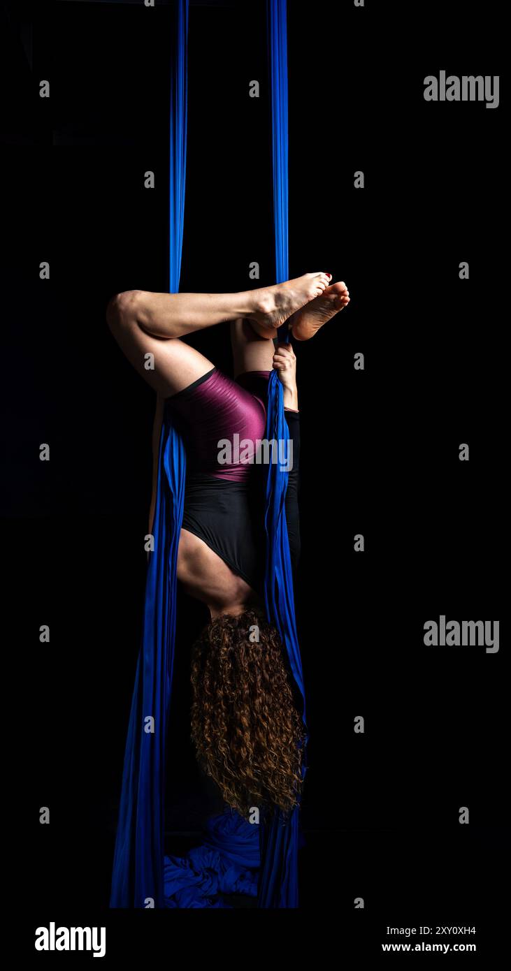 Back view of unrecognizable woman performing an aerial modern dance ...