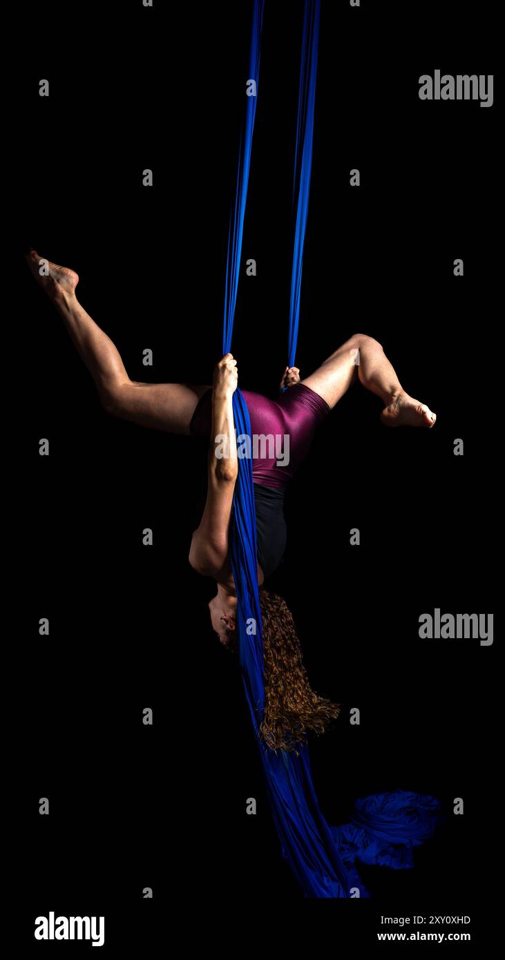 Back view of unrecognizable woman performing a captivating aerial dance ...