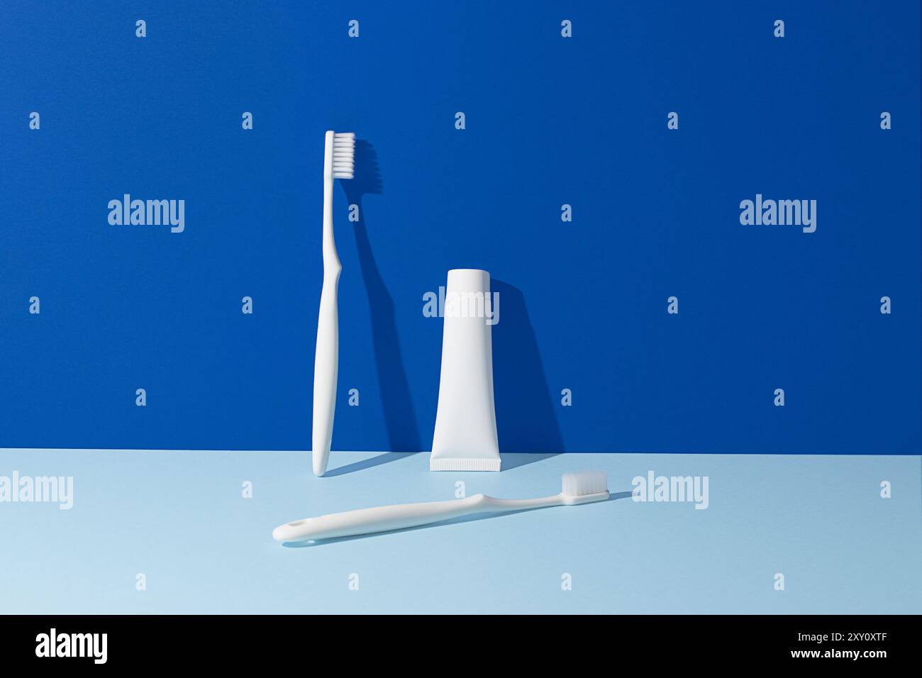 A minimalist display of dental hygiene products, featuring a white ...
