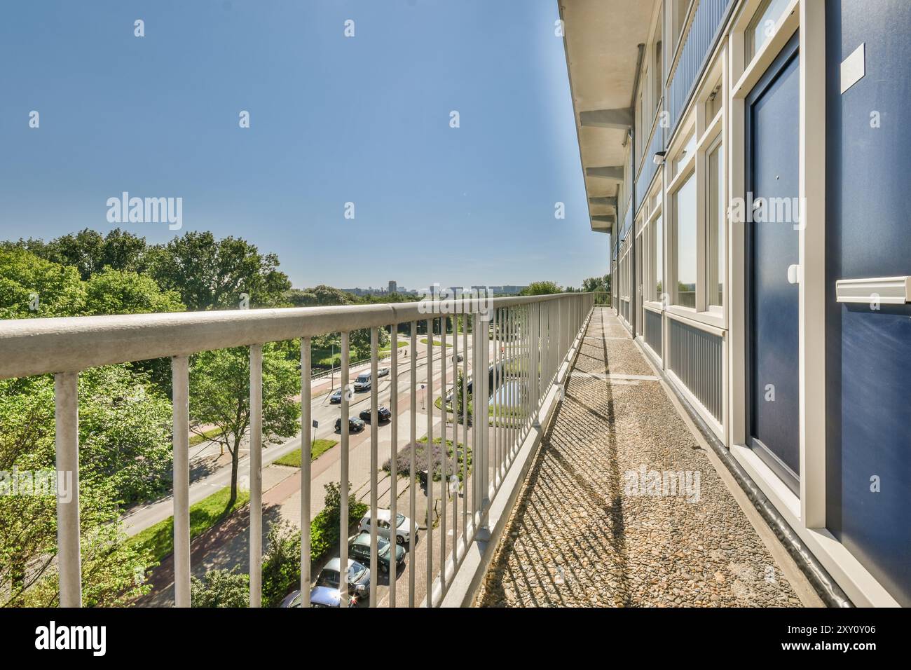 A bright, sunny balcony showcasing a scenic urban view, highlighted by ...