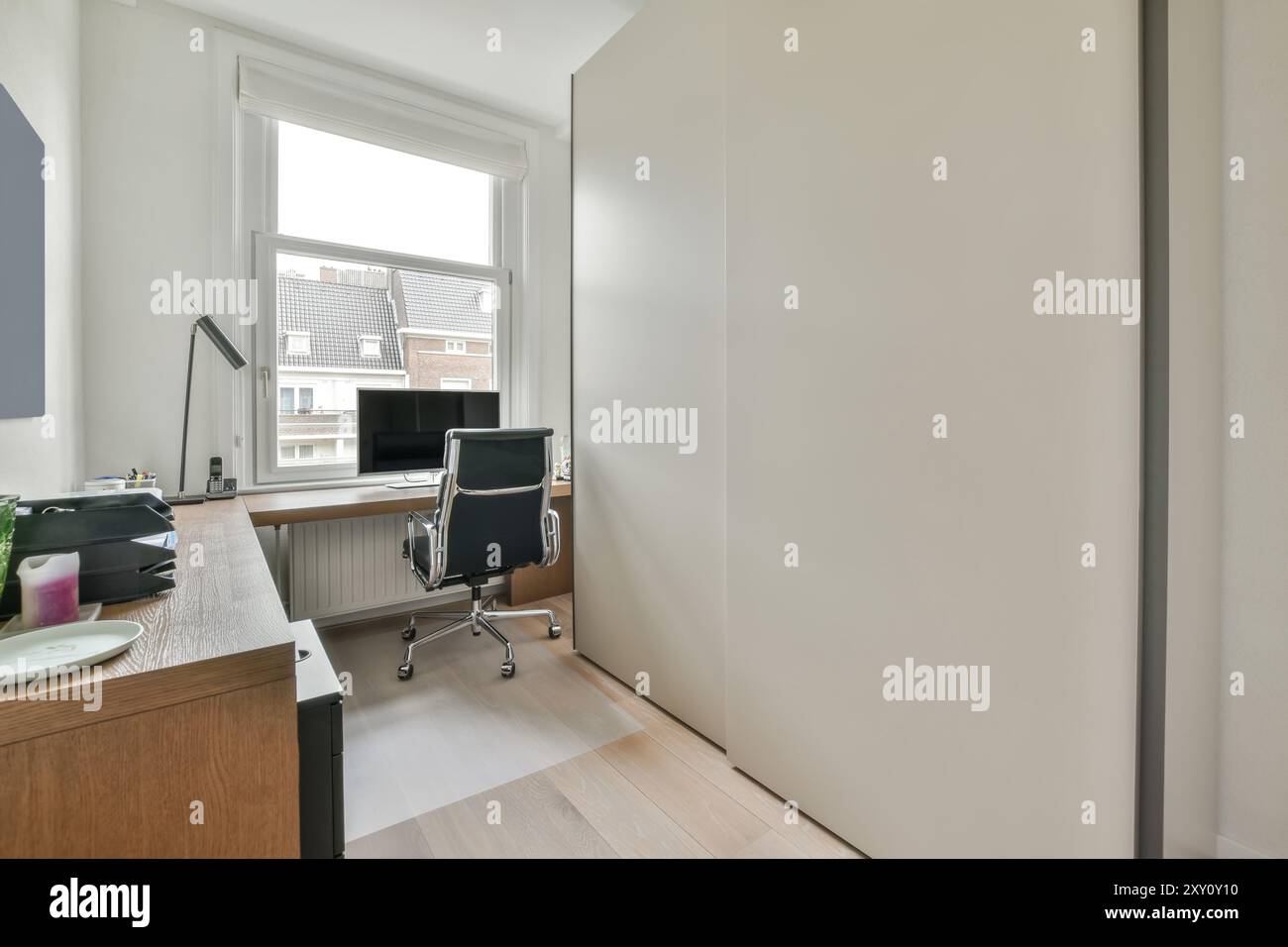 A tidy home office space featuring a wooden desk, ergonomic chair, and ...