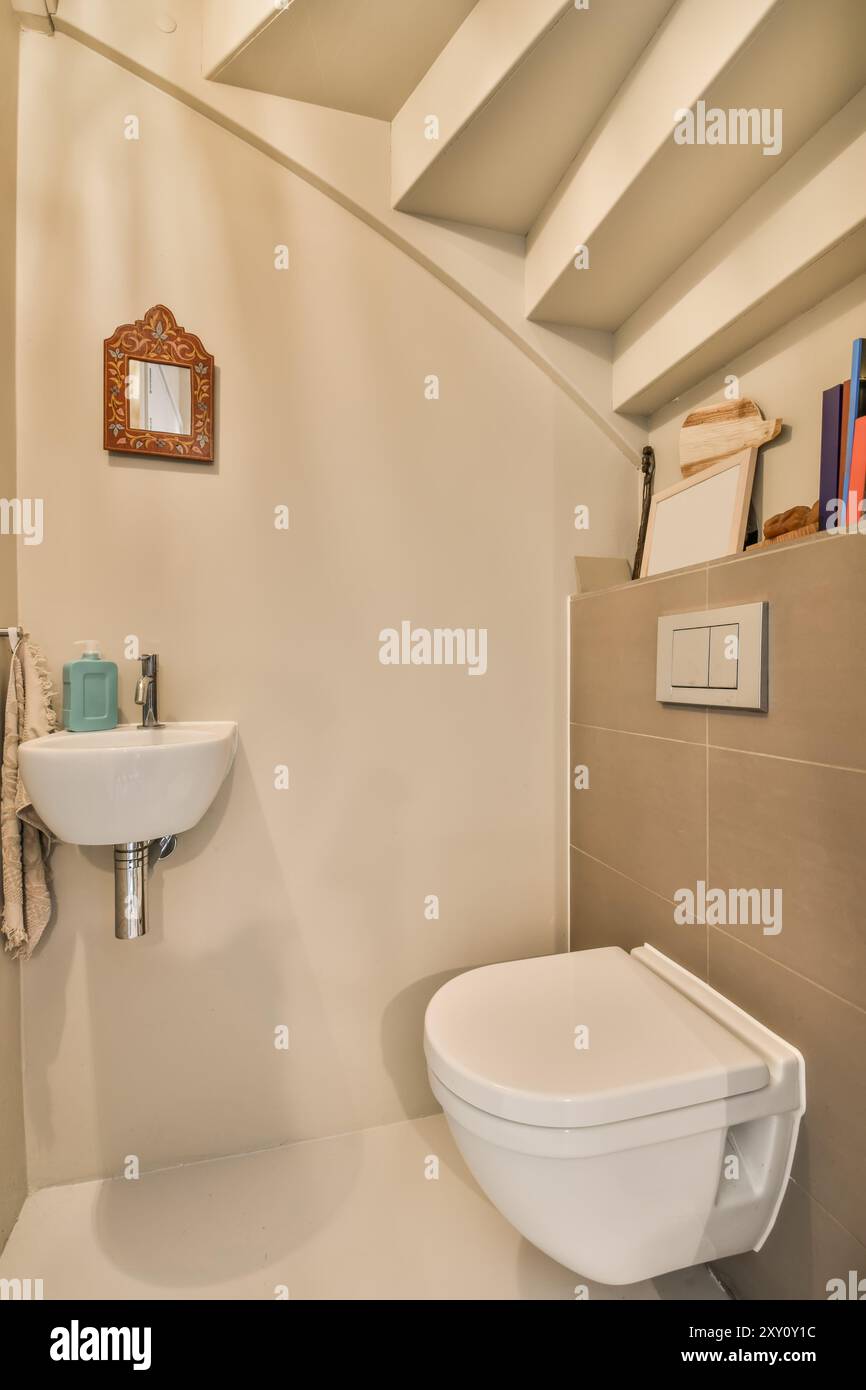 A compact, well-organized corner in a modern bathroom featuring a white ...