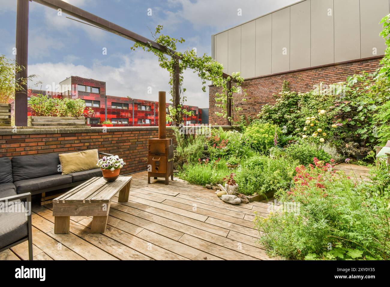 A cozy rooftop garden featuring lush greenery, wooden deck furniture ...