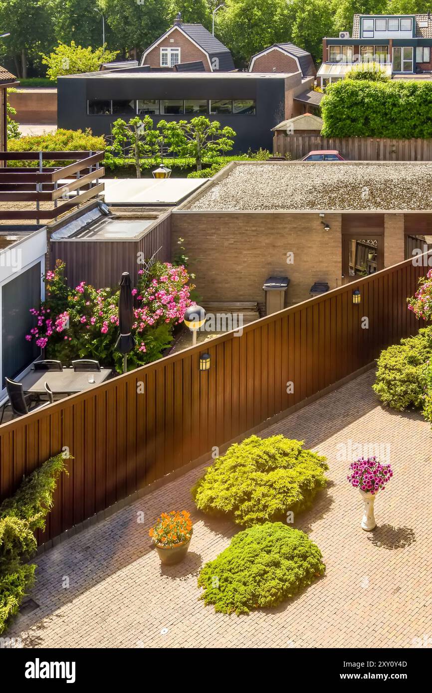 Aerial view of a beautifully landscaped urban garden with a cozy patio ...