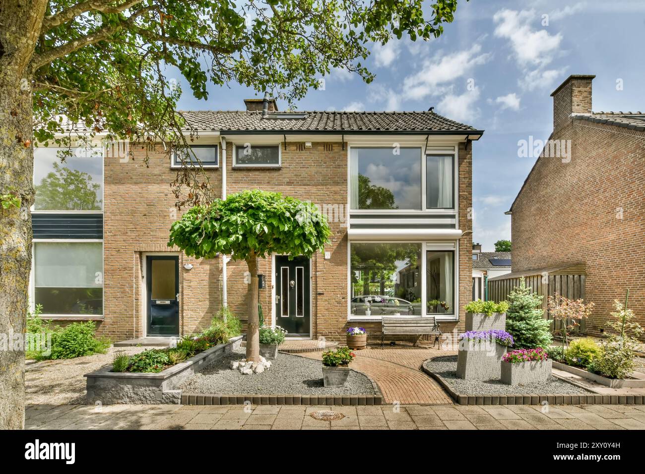 A modern semi-detached house with a beautifully landscaped front garden ...