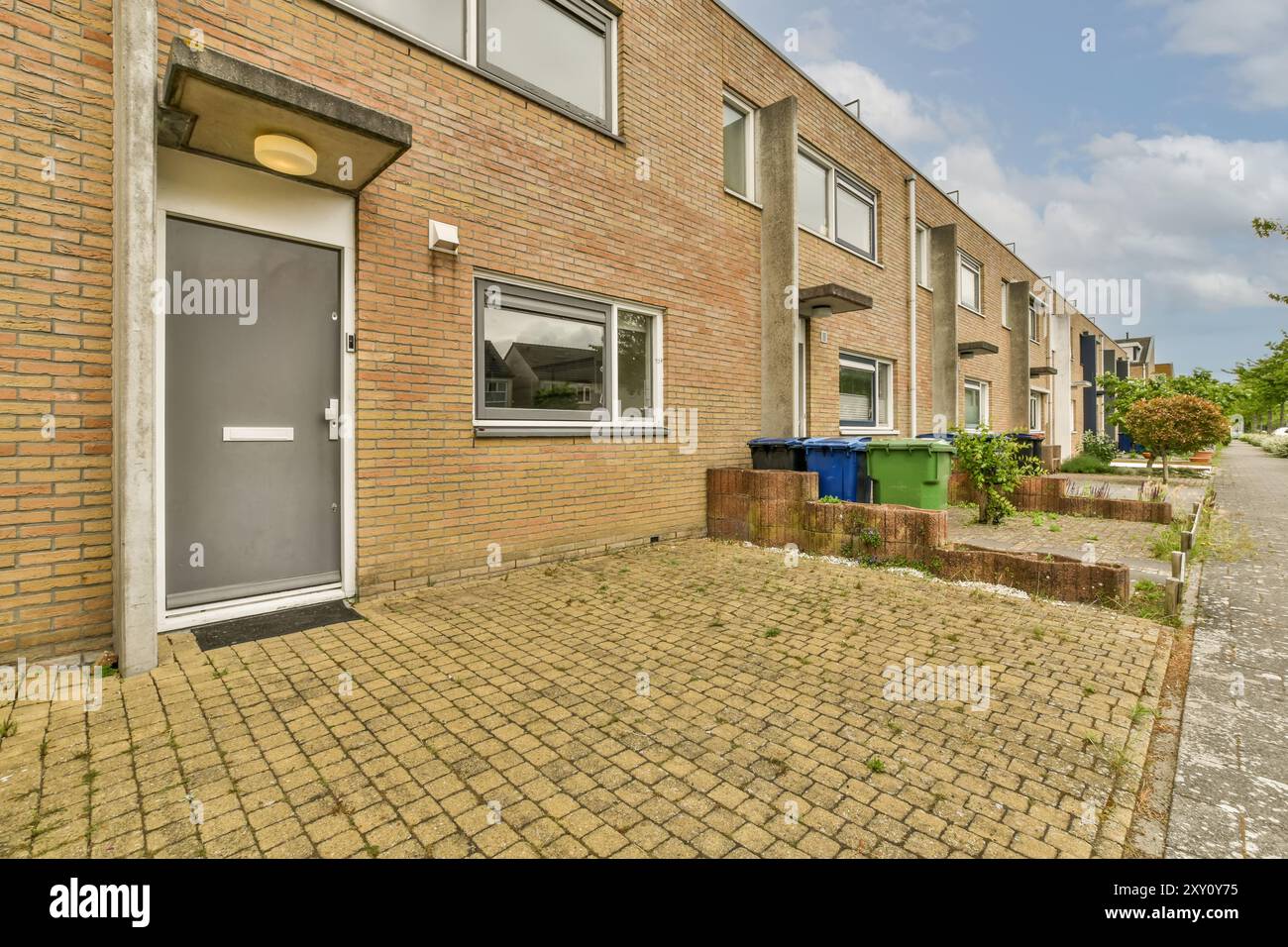 A typical suburban street scene featuring a row of brick houses with ...