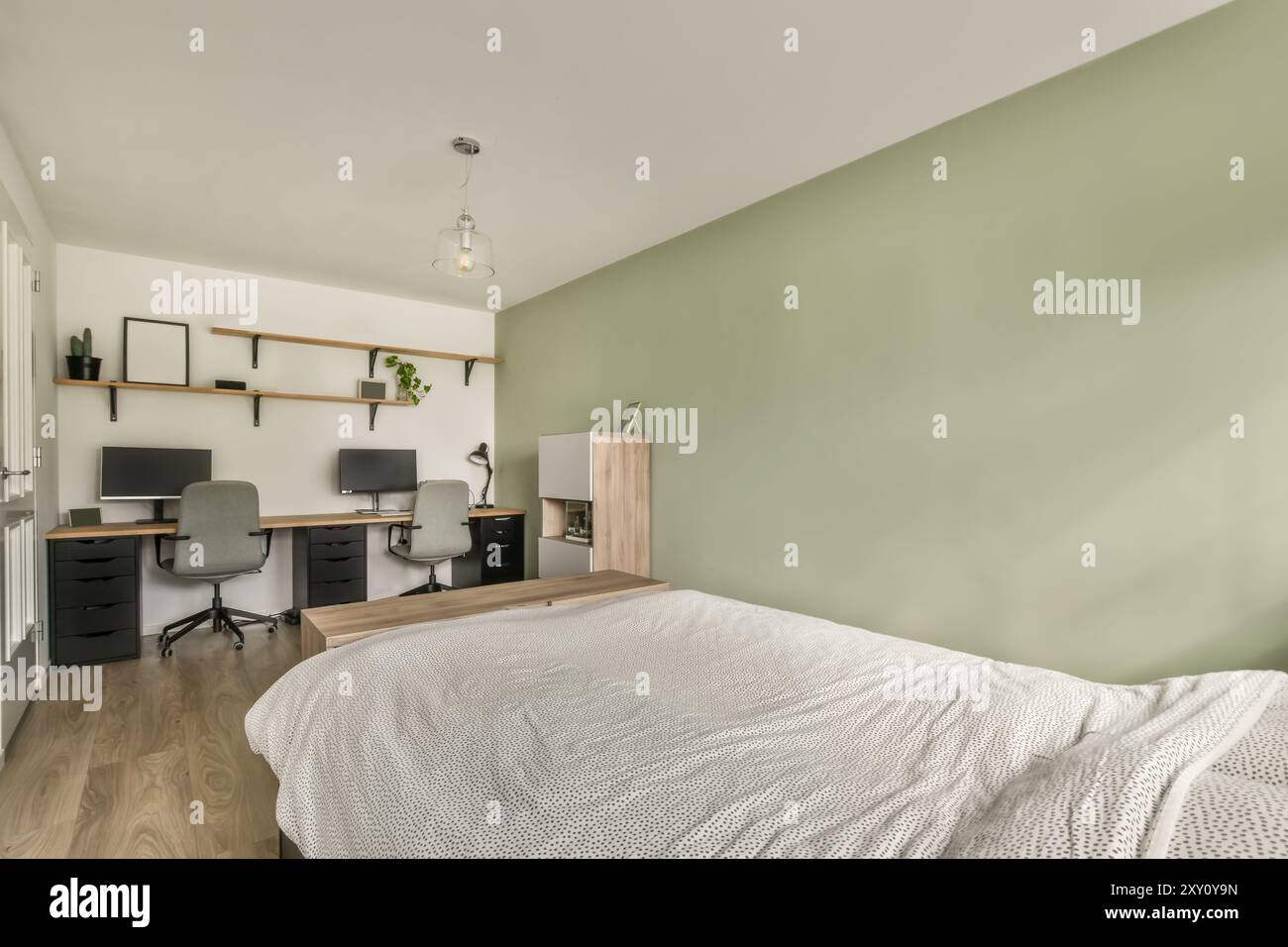 Modern bedroom with a cozy bed and a well-organized workspace featuring ...
