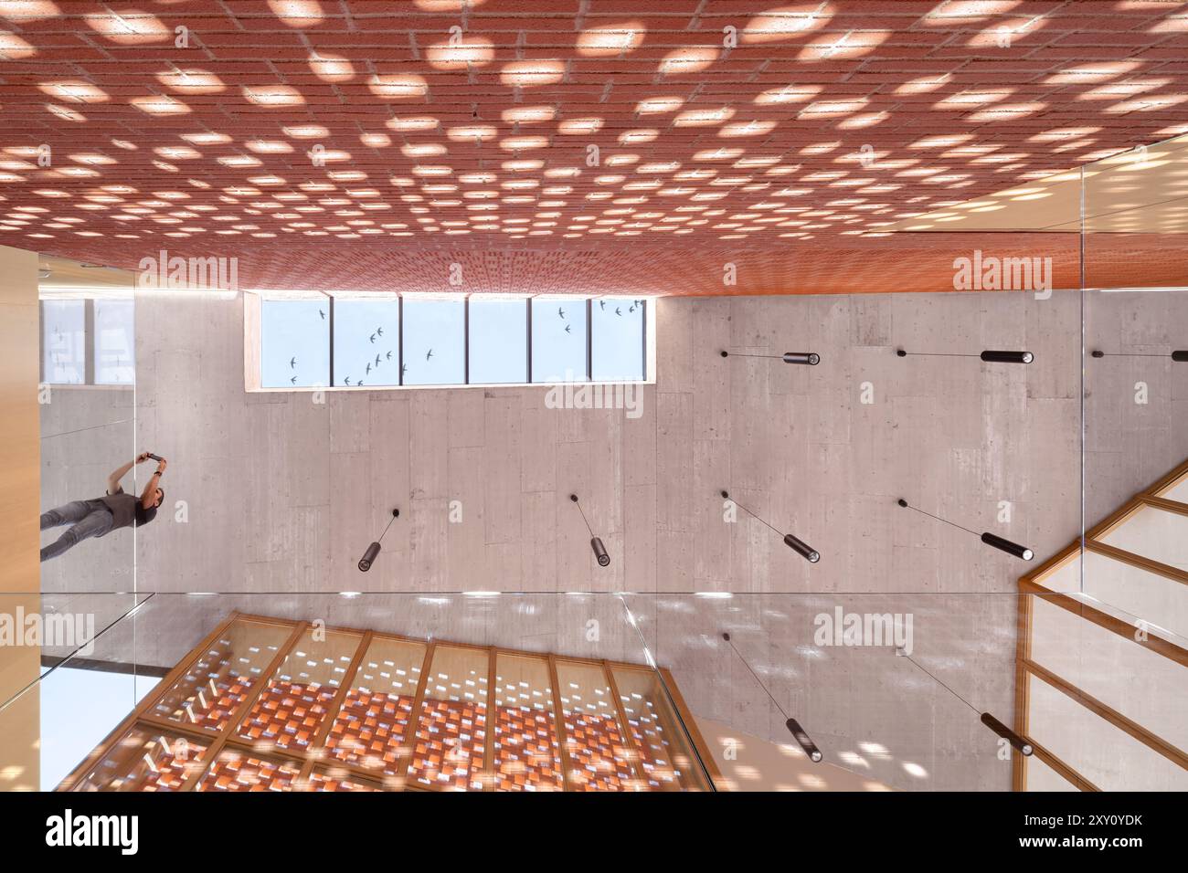 This striking auditorium interior showcases a sleek concrete finish and ...
