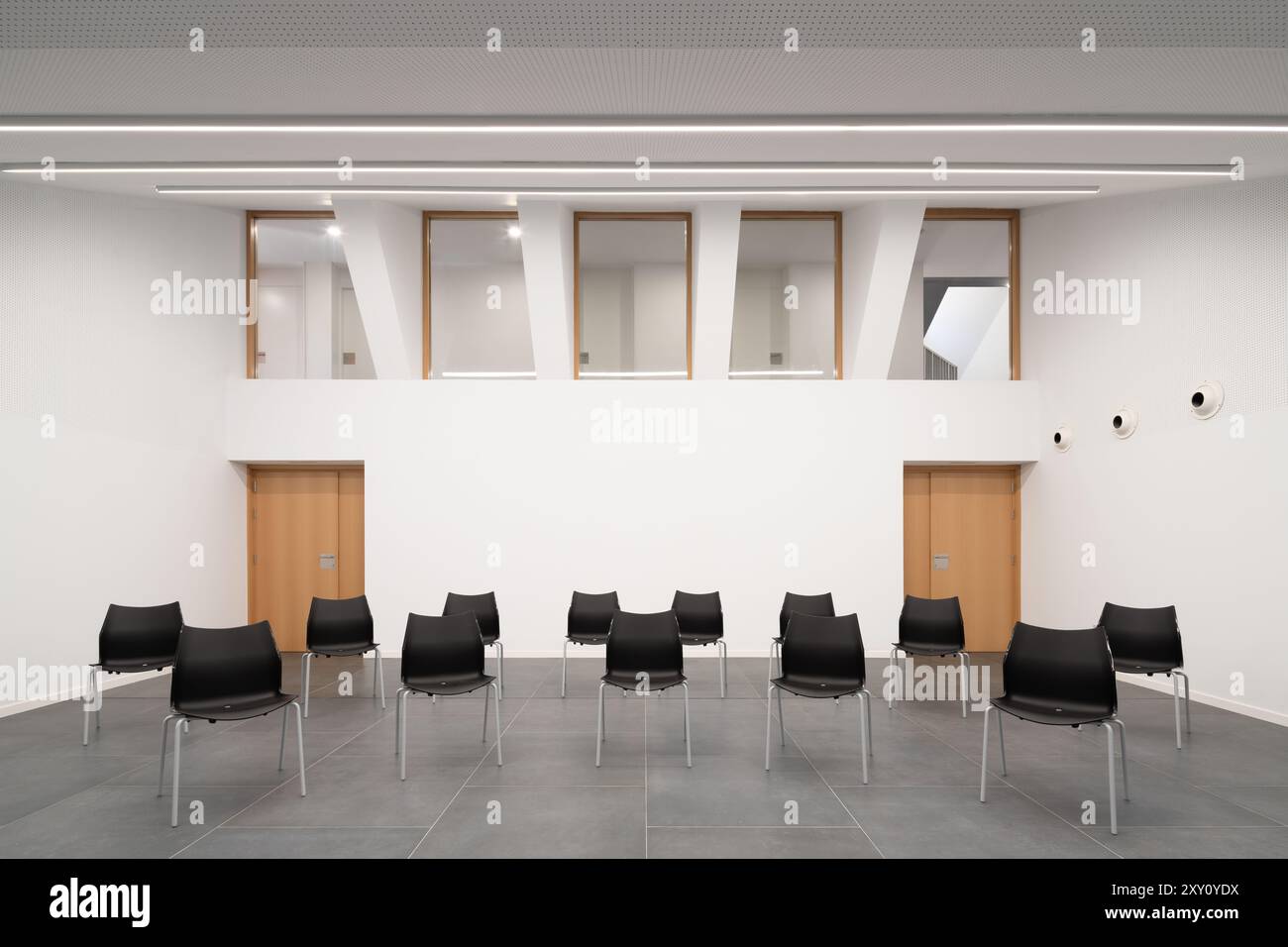 This image showcases a contemporary auditorium interior featuring rows ...