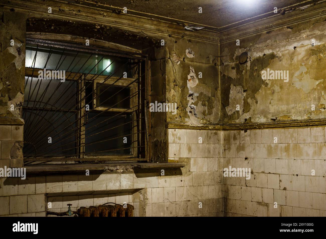A creepy room in an old building with walls covered in soot and a ...