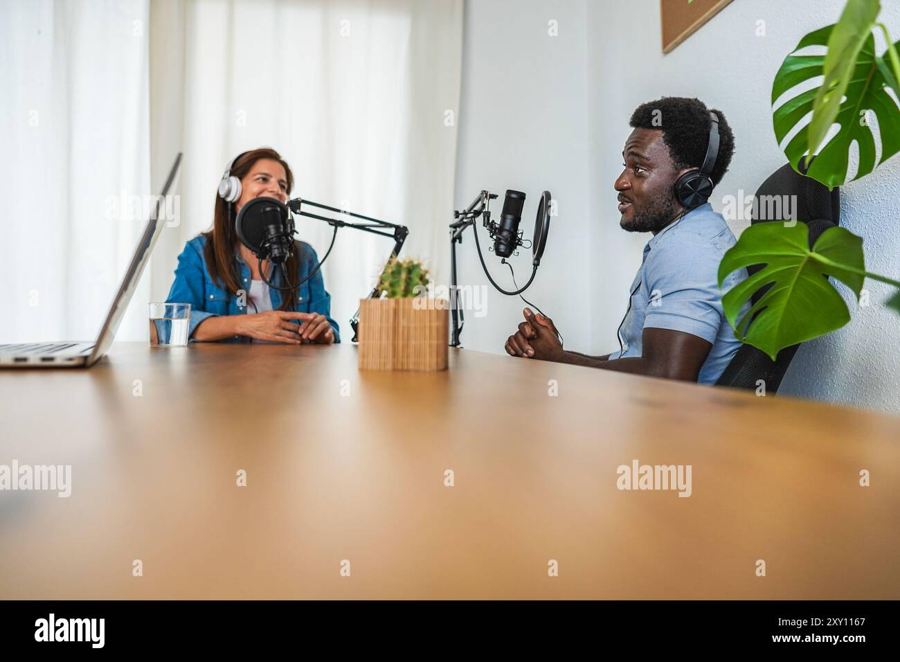 Woman hosting podcast session indoor - Female speaker making an ...