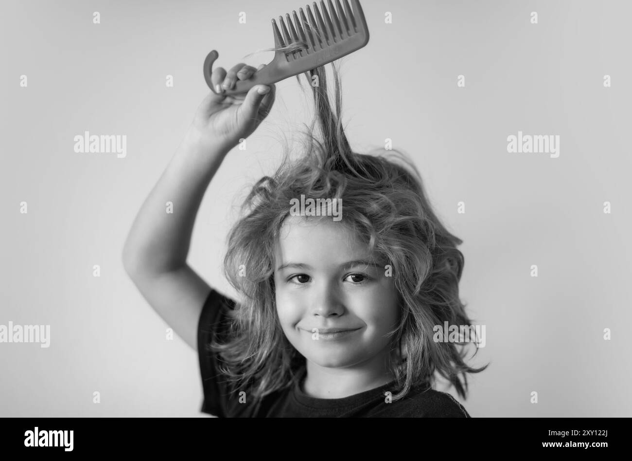Tangled kids hair. Cute child with comb. Blonde kid combs unruly hair ...