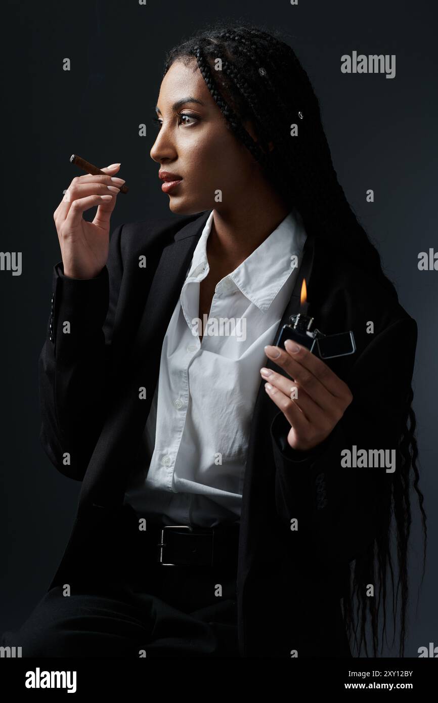 A young woman in a white shirt and black blazer poses against a gray ...