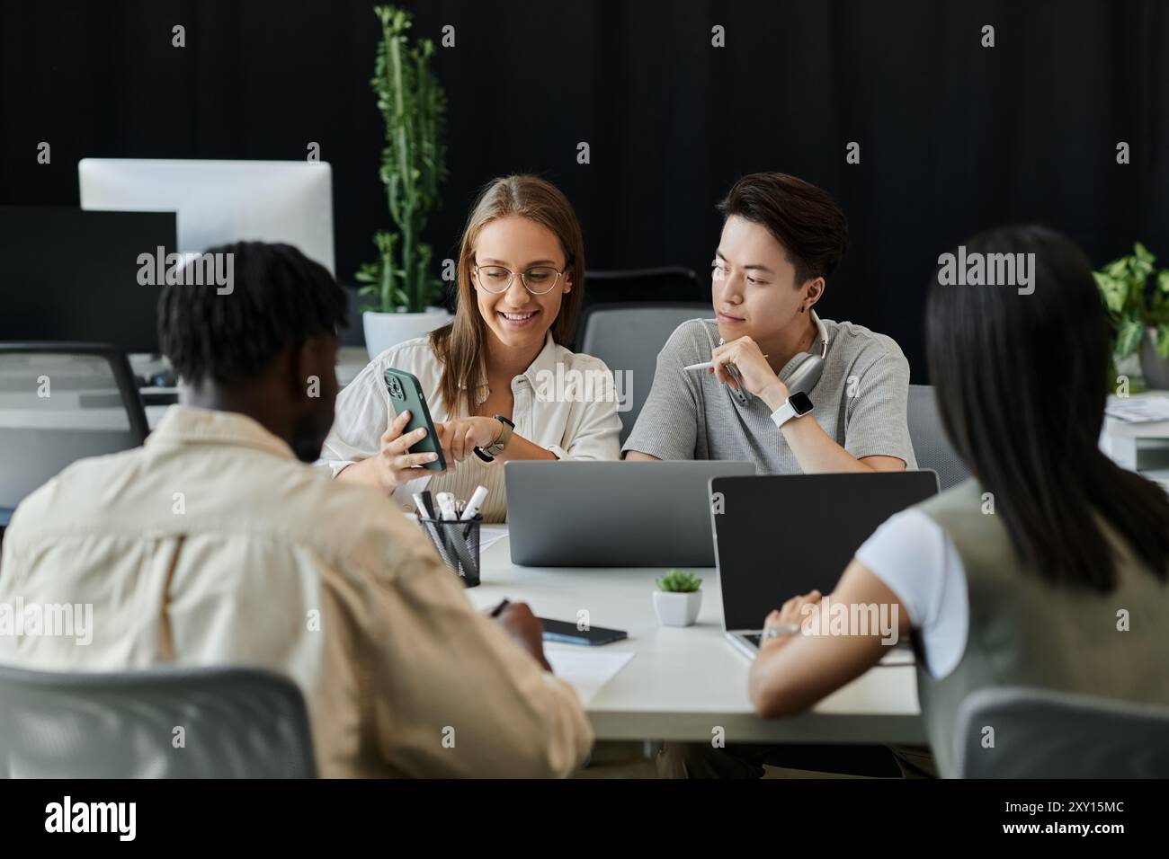 Diverse team collaborates on mobile hi-res stock photography and images ...