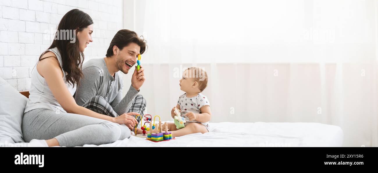 Young Family Engaging in Playtime Activities Together in Bright Bedroom ...