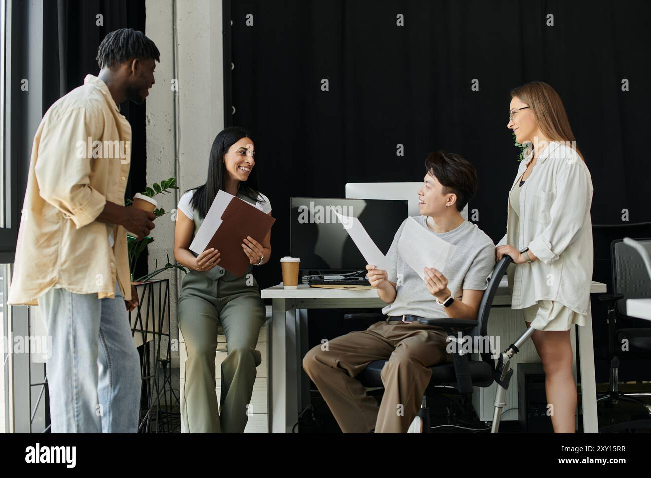 A diverse team of four works on a startup project, with one team member ...