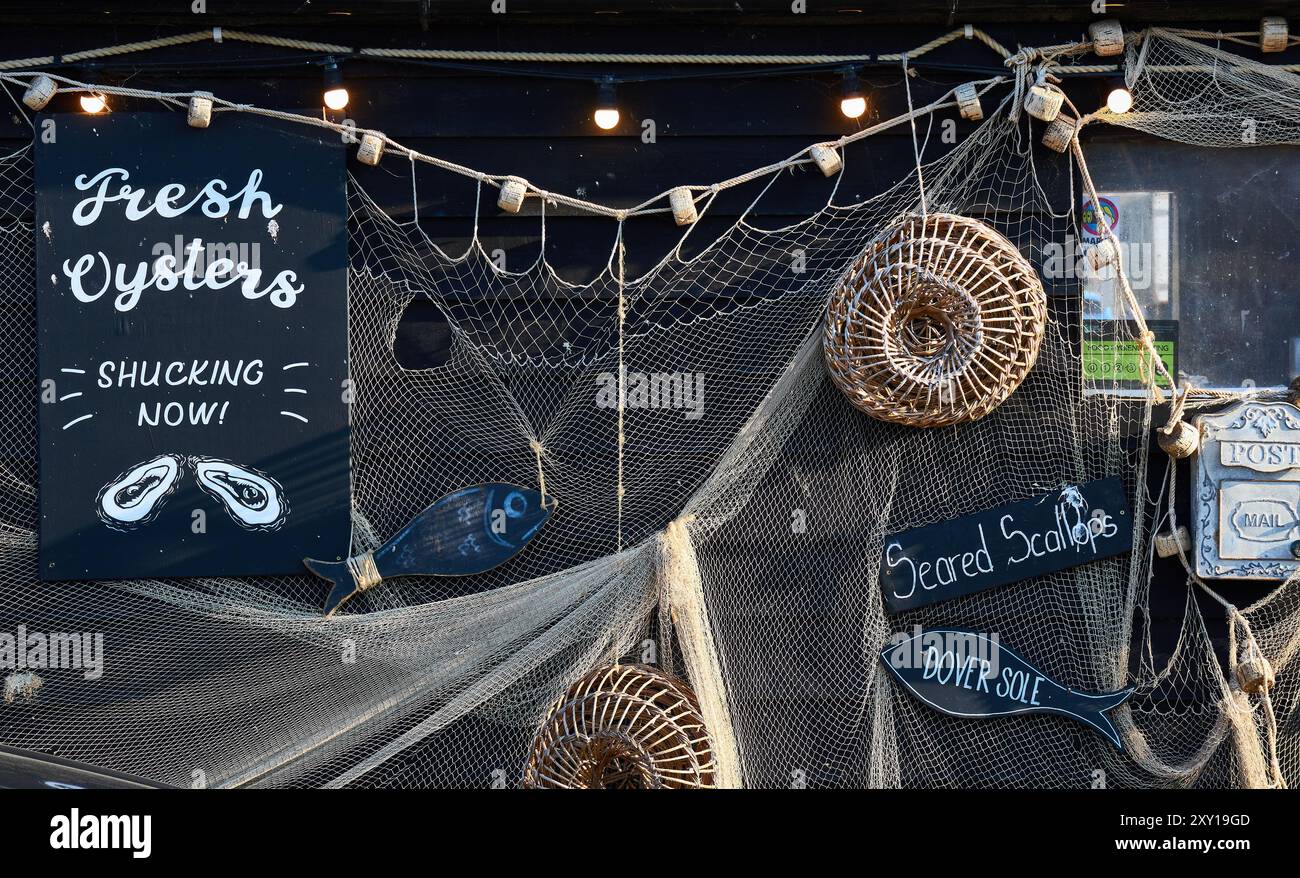 The outside of a fishing hut on Aldeburgh beach showing fishing nets ...
