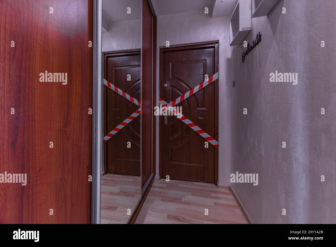 The entrance door to the apartment, police tape, secured the crime ...
