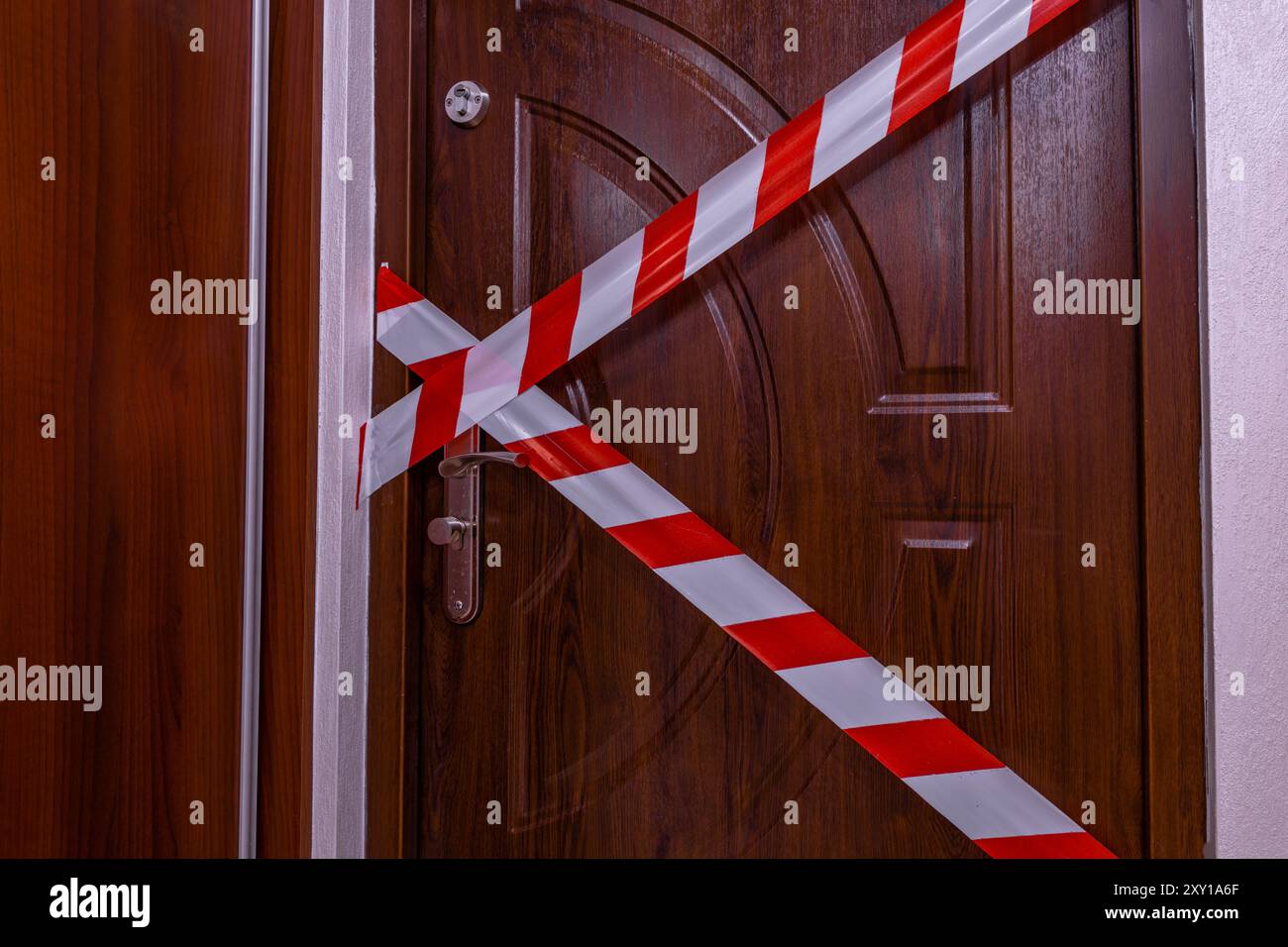 The entrance door to the apartment, police tape, secured the crime ...
