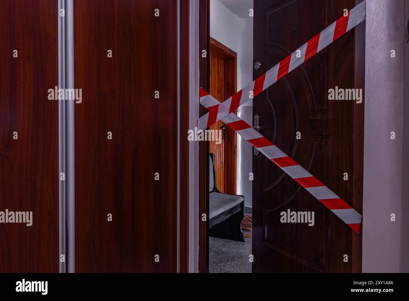 The entrance door to the apartment, police tape, secured the crime ...