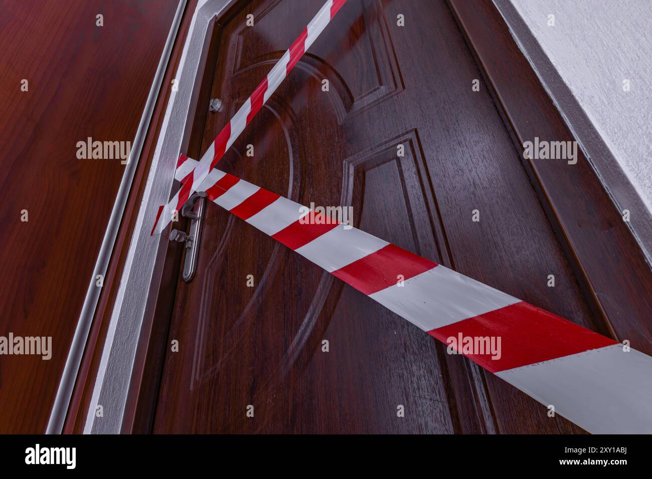 The entrance door to the apartment, police tape, secured the crime ...