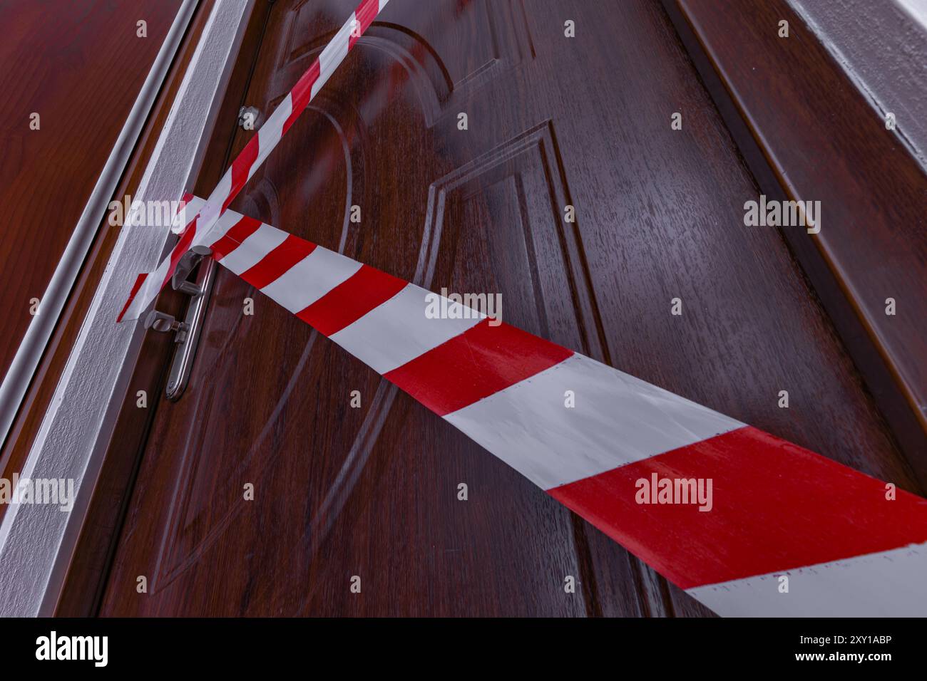 The entrance door to the apartment, police tape, secured the crime ...