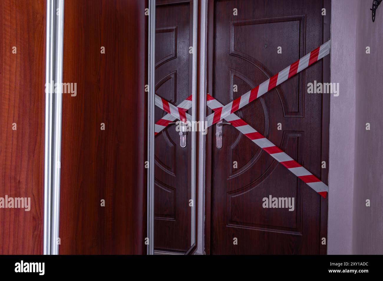 The entrance door to the apartment, police tape, secured the crime ...
