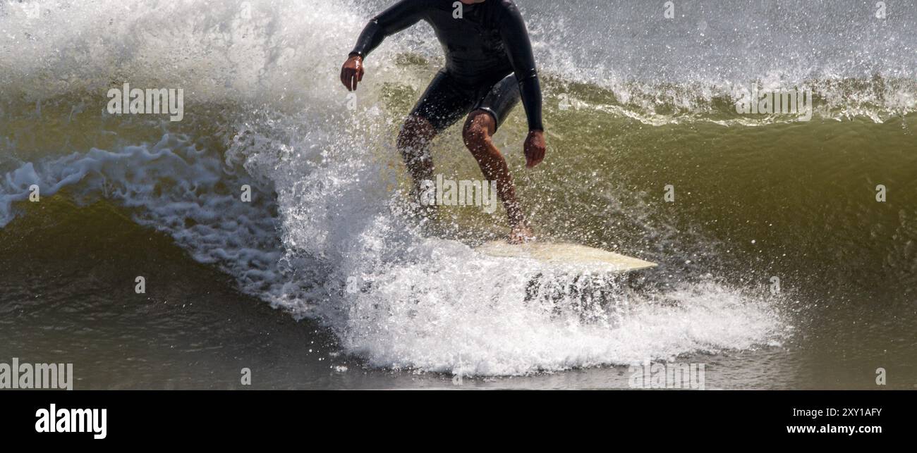 Front view of a surfer managing very rough storm waves close up in the ...